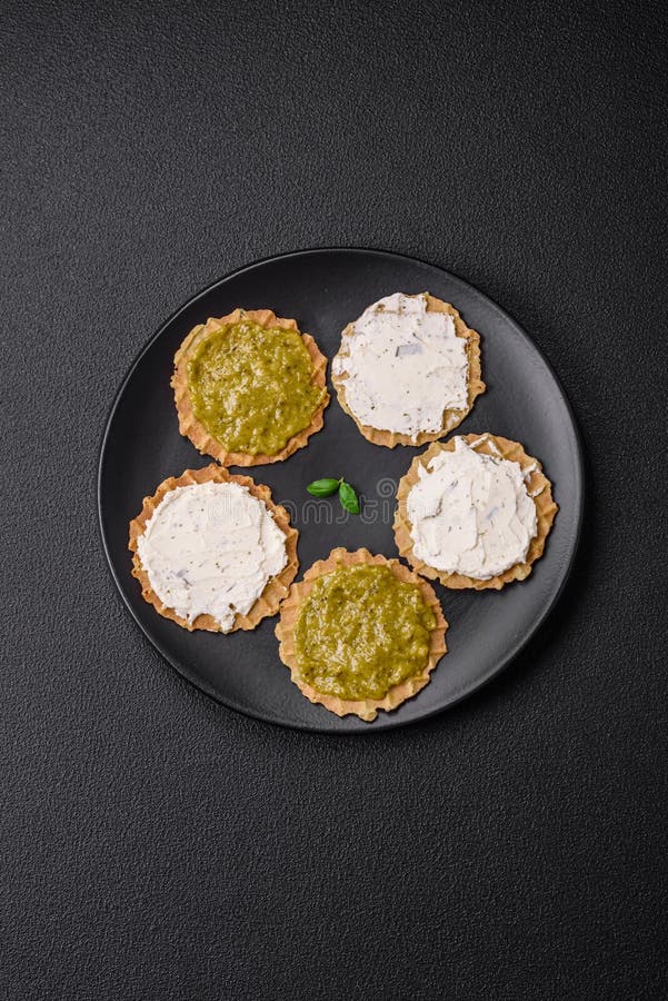 Round Snacks with Crispy Chips or Crackers with Cream Cheese and Pesto ...