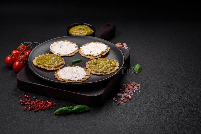 Round Snacks with Crispy Chips or Crackers with Cream Cheese and Pesto ...