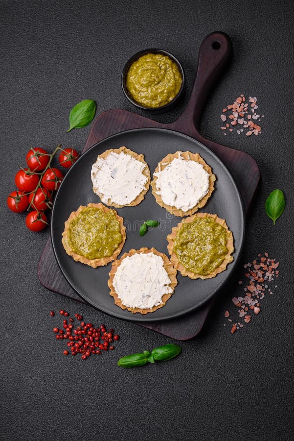 Round Snacks with Crispy Chips or Crackers with Cream Cheese and Pesto ...