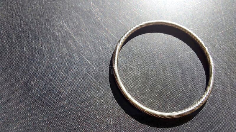 Round Spring Placed on a Smooth Surface Reflecting Sunlight Creating ...