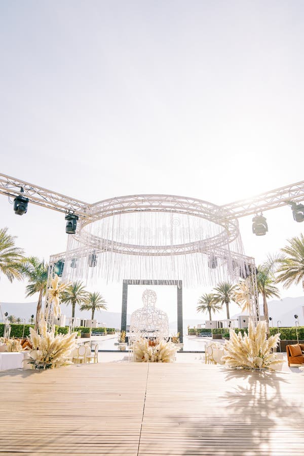 Round Stage Decorated with Bouquets of Flowers with Spotlights on ...