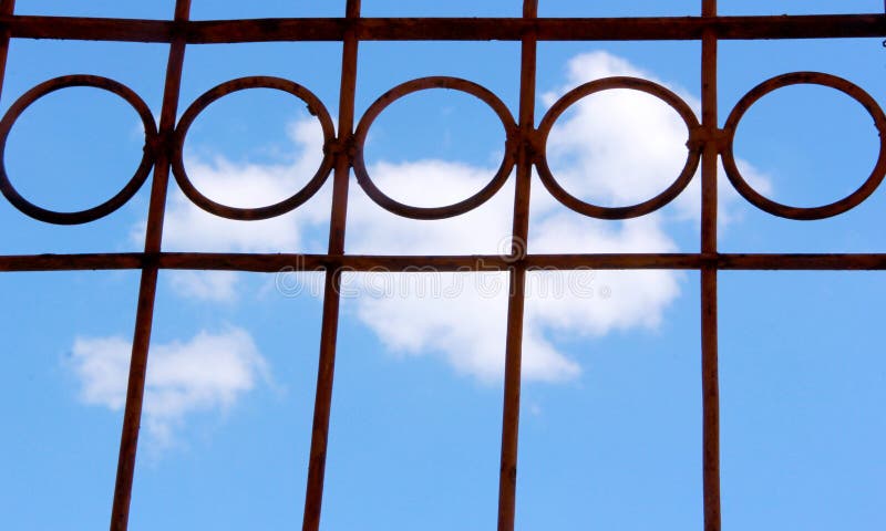 Round Steel Fence with Blue Sky and Clouds Background Stock Photo ...