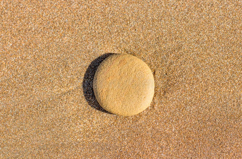 Round Stone in the Wet Sand Stock Photo - Image of single, center: 38310968