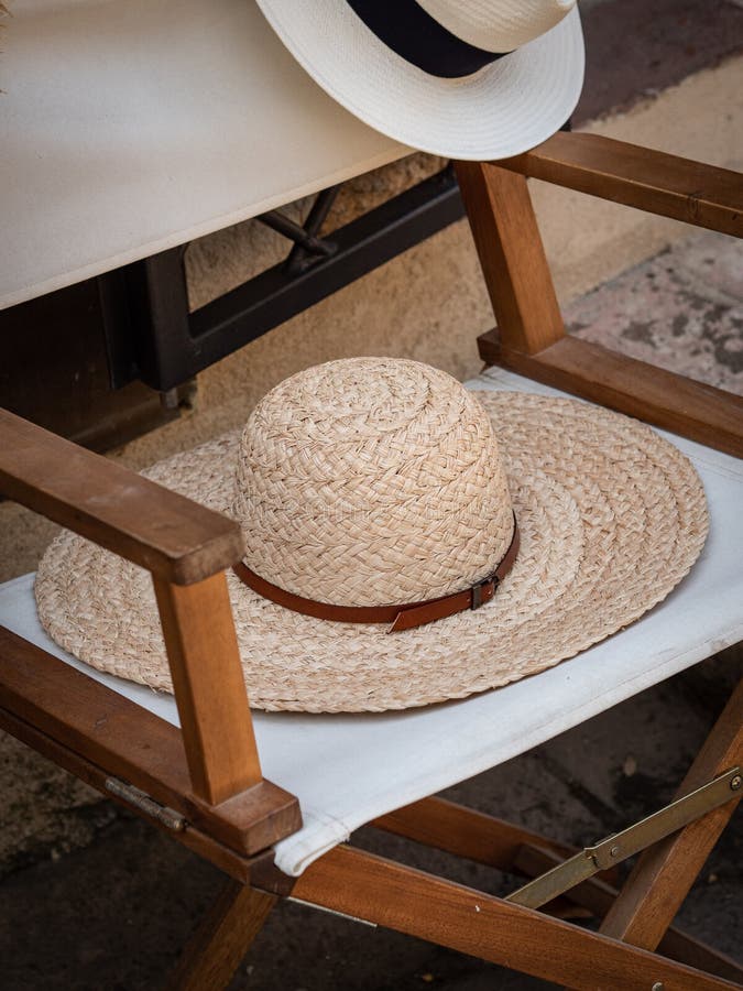 Round Straw Hat Resting on a Chair Outdoor Stock Photo - Image of ...