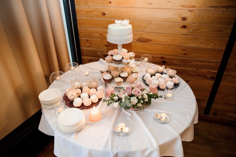 Round Table Covered with a White Tablecloth and Served with Cakes Stock ...