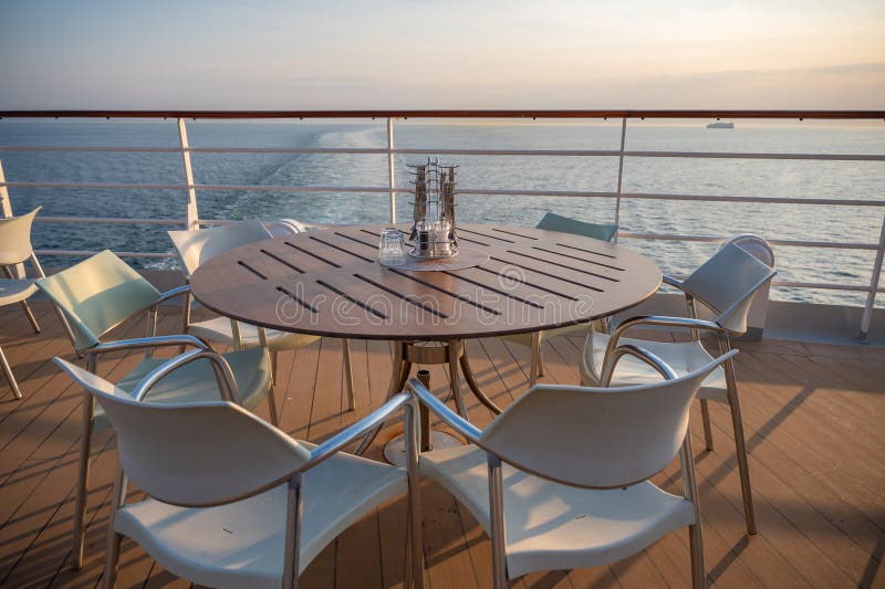 Round Table with Empty Chairs on Boat Deck of a Cruise Ship during ...