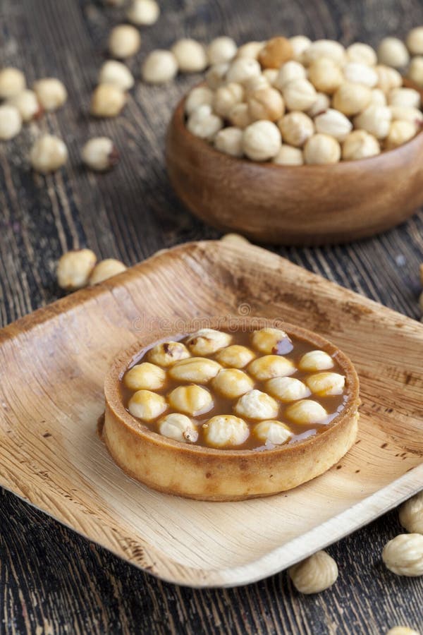 Round Tartlet with Soft Caramel and Roasted Hazelnuts Stock Photo ...