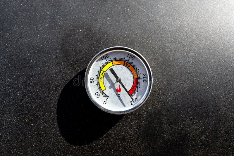 A Round Thermometer Showing 250 Degrees Celsius Placed on a Charcoal ...