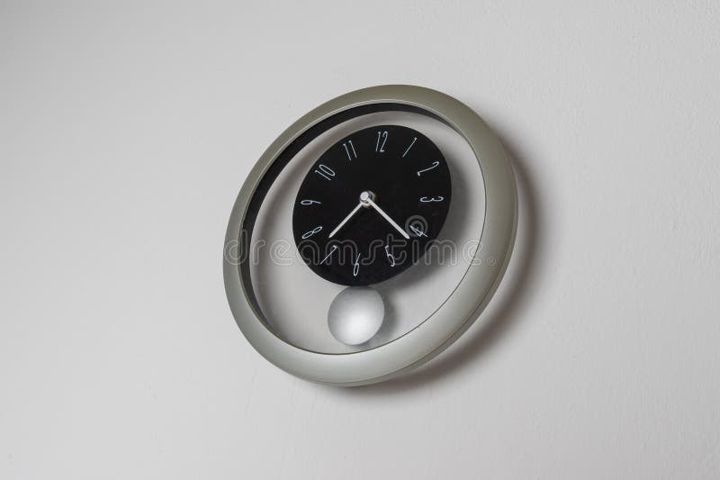 Round Wall Clock on a White Wall. There are Numbers on the Clock Stock ...