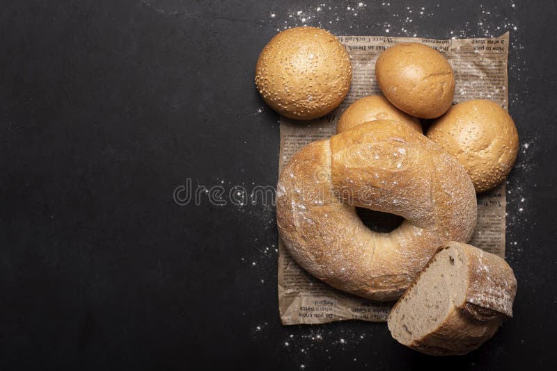 Round Wheat Bread and Sesame Buns on Parchment Stock Image - Image of ...