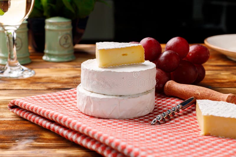 Round White Cheese with Grapes on Wooden Table Stock Image - Image of ...