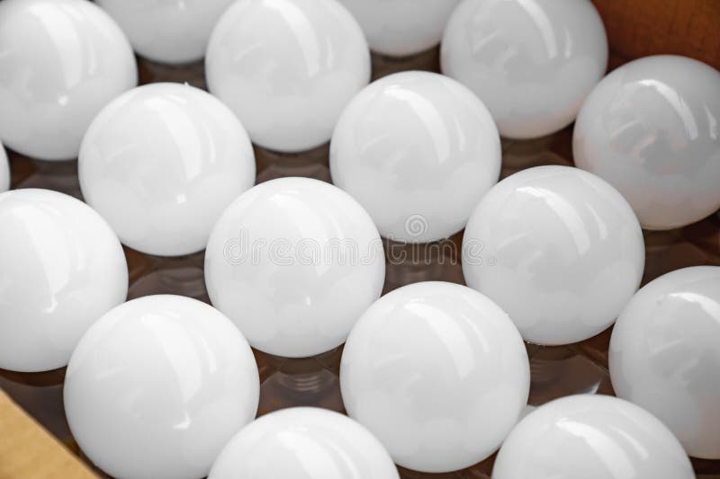 Round White LED Light Bulb. Many Modern Light Bulbs in the Box Stock ...