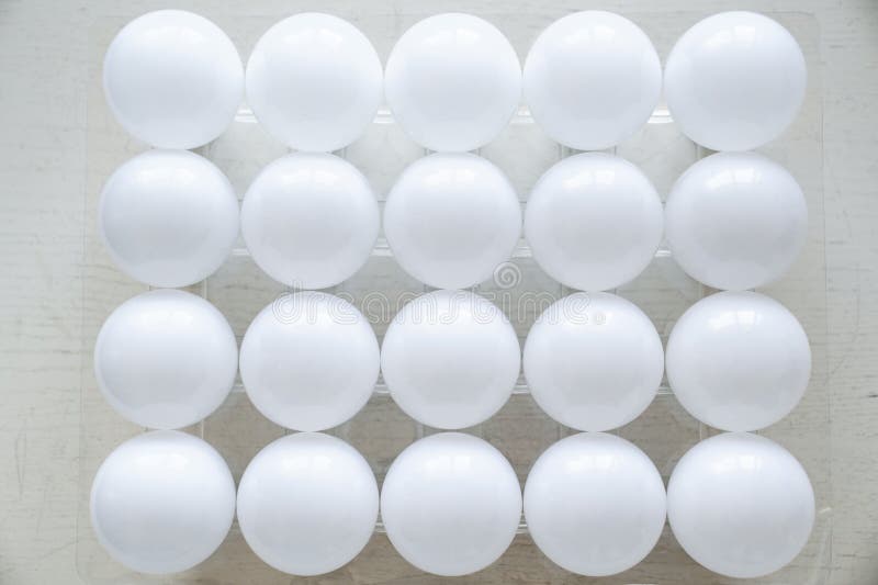 Round White LED Light Bulb. Many Modern Light Bulbs on a White Table ...