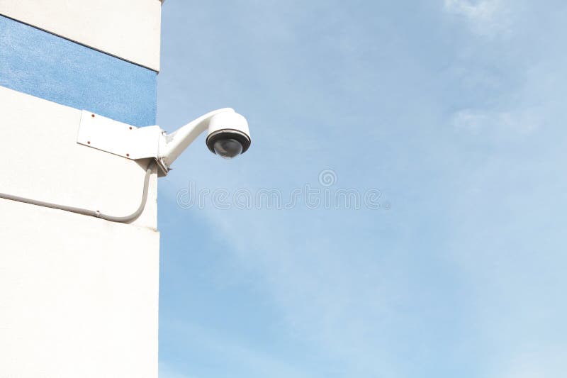 Round Wide Angle Security Camera Mounted on Corner of Building Wall in ...