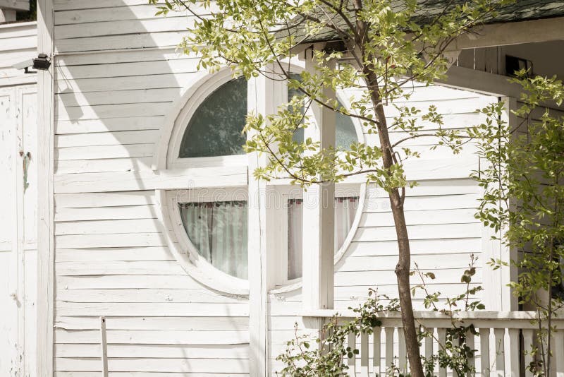 Round Window on White Wooden House Stock Photo - Image of frame, tree ...