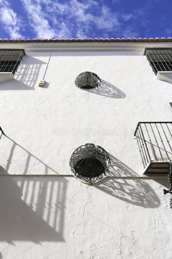 Round Windows with Wrought Iron Lattice on Whitewashed Facade Stock ...