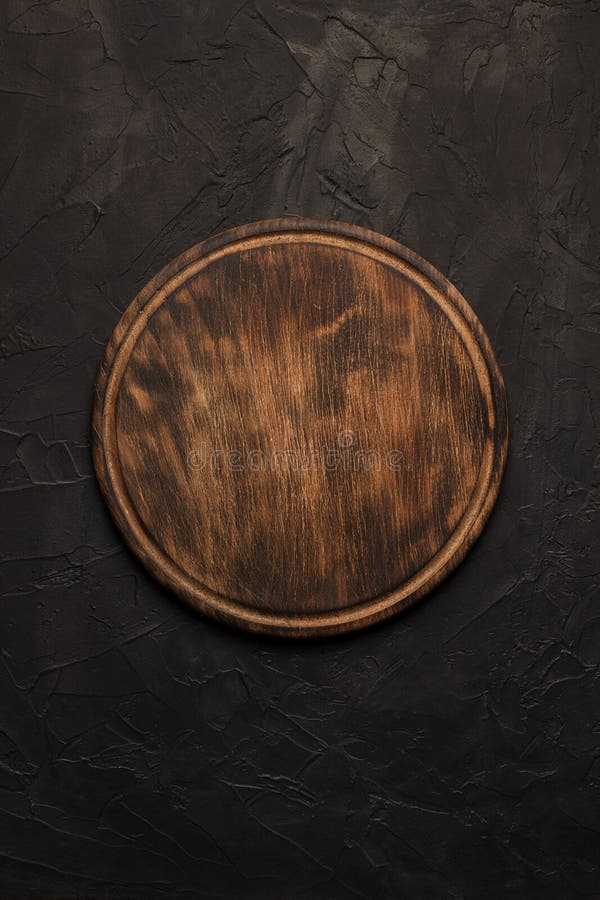 Round Wooden Cutting Board on a Black Table. Top View of Empty Kitchen ...