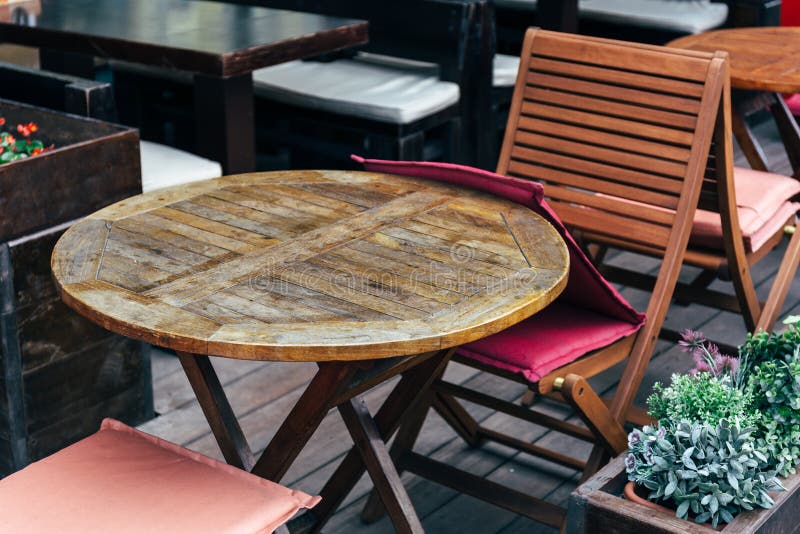 Round Wooden Table and Chairs in a Street Cafe Stock Image - Image of ...