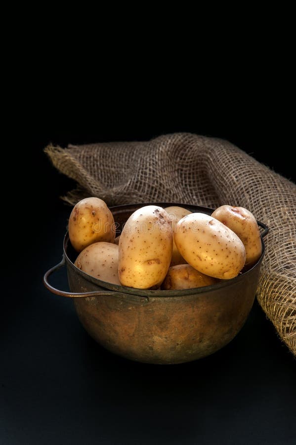 Round Yellow Potatoes Lying in the Pot and on the Table the Lighting is ...