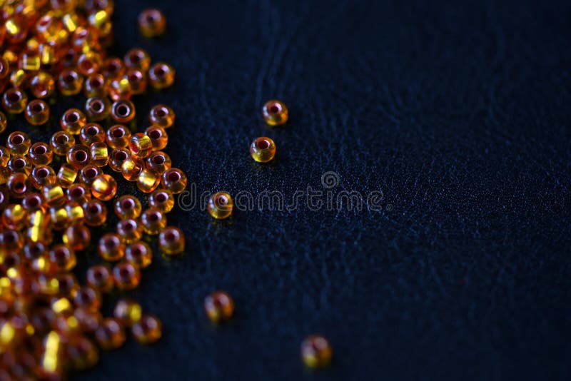 Round Yellow Seed Beads Scattered on a Dark Surface Stock Image - Image ...