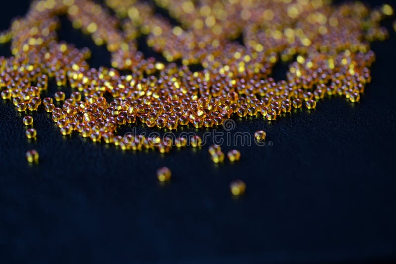Round Yellow Seed Beads Scattered on a Dark Surface Stock Photo - Image ...