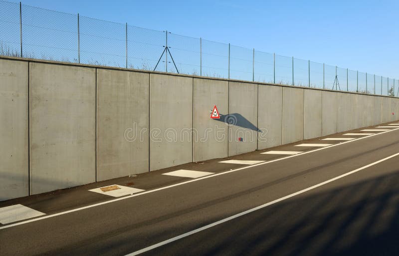 Roundabout Warning Triangle Road Sign, on Concrete Wall at the Exit of ...