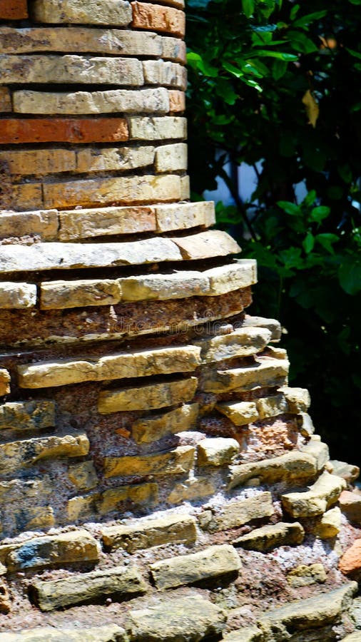 Rounded Corner of Ancient Brick Wall and Stone Scraps with a Geometric ...