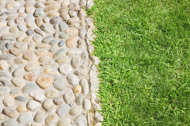 Rounded Pebble Floor with Polished Stone and Grass Area Stock Photo ...