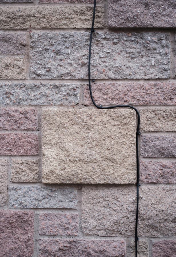 Routed Cable on Wall stock photo. Image of brickwork - 382304172