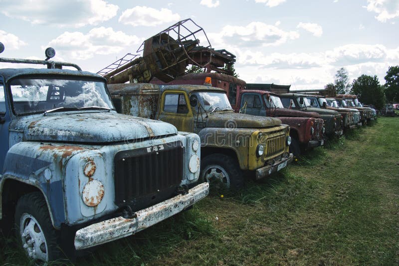 Row of Abandoned Soviet Trucks in a Rural Field - Vintage Industrial ...