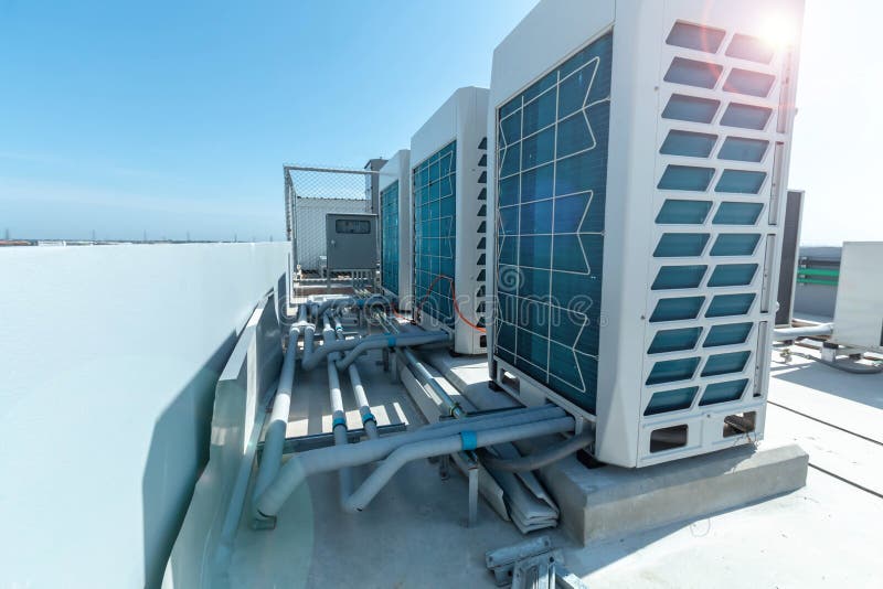A Row of Air Conditioning Units on Rooftop with Blue Sky Stock Photo ...