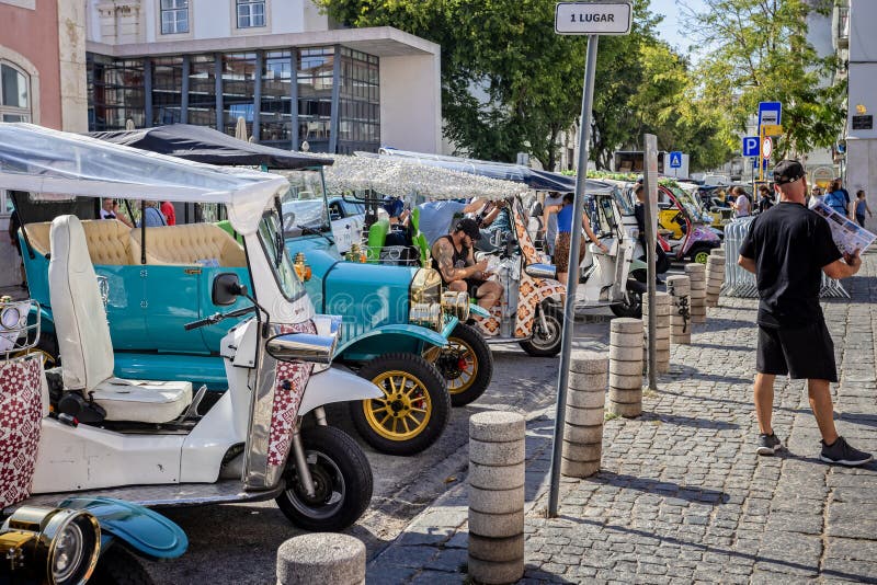 Row of Assorted Tuk Tuks Waiting for Tourists in Lisbon, Portugal ... Row of Assorted Tuk Tuks Waiting for Tourists in Lisbon, Portugal ...