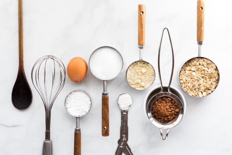 A Row of Baking Utensils and Ingredients on White Marble. Stock Image ...