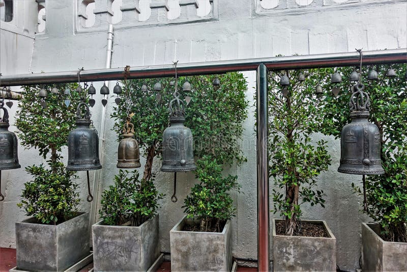 A Row of Bells on the Background of a White Wall of the Temple. Stock ...