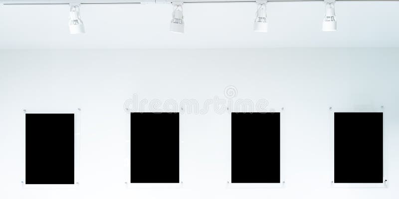 A Row of Black Frames Hang from a White Wall. the Frames are All ...