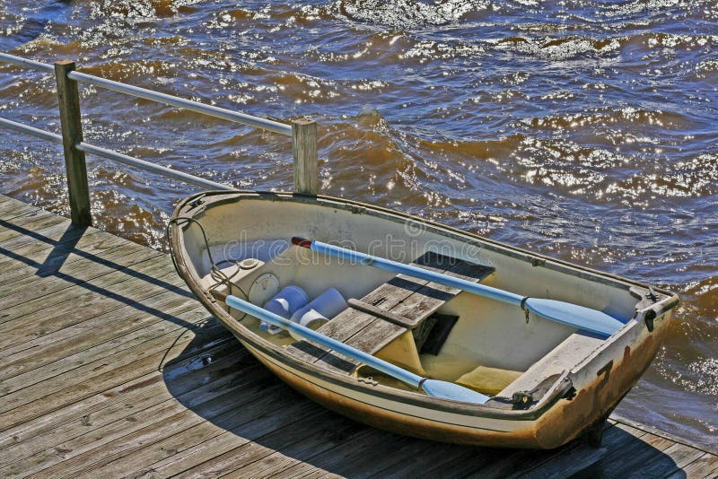 A Row Boat on a Dock with Blue Oars Stock Photo - Image of colored ...