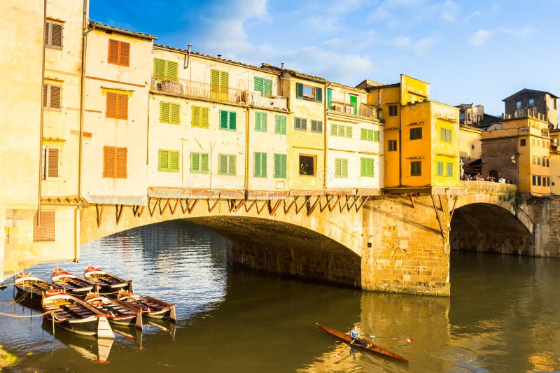 Row Boat Going Under the Historic Ponte Vecchio Bridge in Florence ...