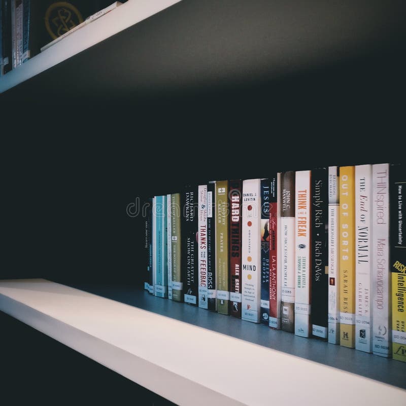 Row of books in library editorial photo. Image of books - 204469711