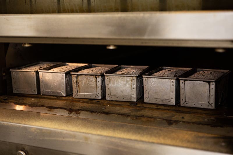 Row of Bread Loaves in the Silver Baking Boxes in the Oven Stock Image ...