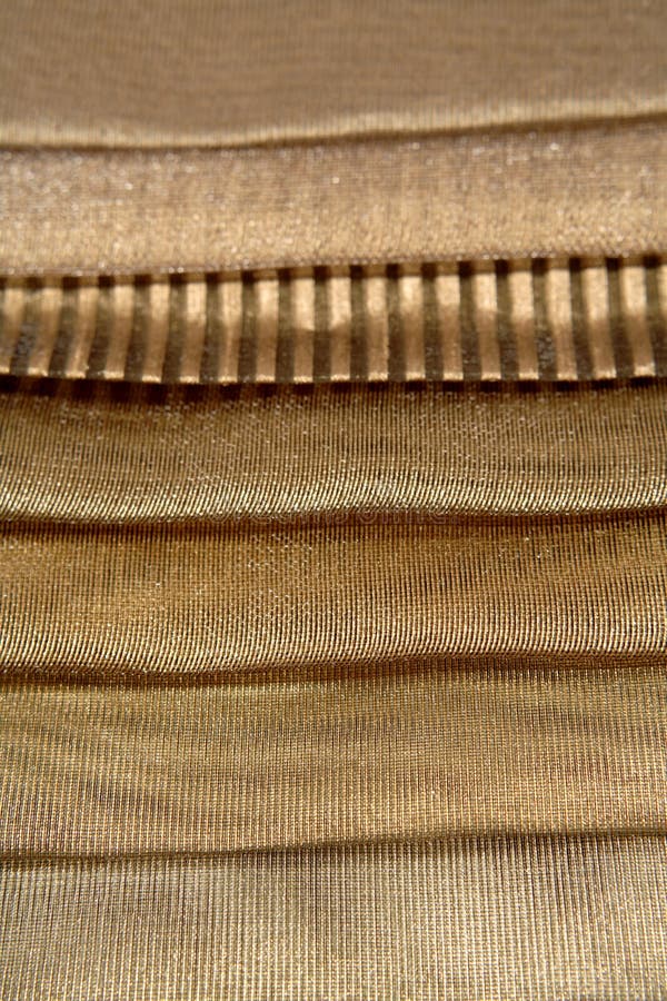 Row Of Brown And Gold Fabrics Stock Photo - Image of stacked, bright ...