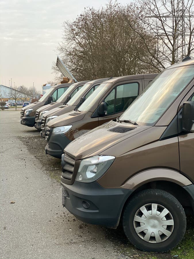 Row of Brown Transportation Delivery Vans Being Parked in Front of ...