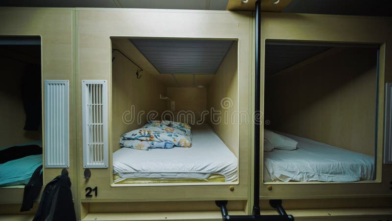 Row of Capsule Hotel Rooms Offering Comfortable and Affordable ...
