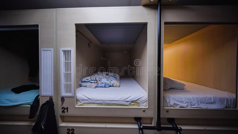Row of Capsule Hotel Rooms Offering Comfortable and Private Sleeping ...