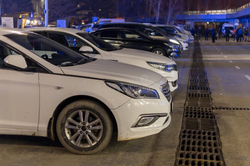 Row of Cars Parked in Front of Airport at Night Editorial Stock Image ...