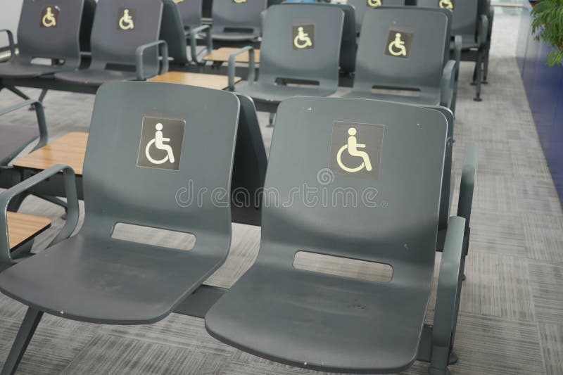 Row of Chairs with a Sign for Disable Stock Photo - Image of sign, real ...