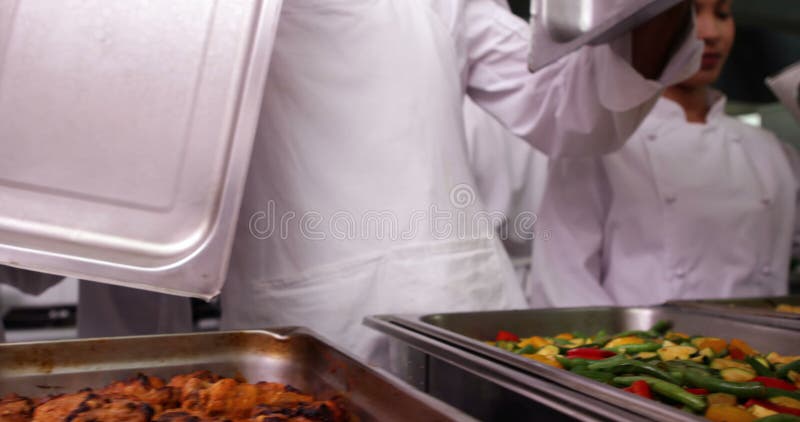 Row of Chefs Lifting Lid Off Serving Trays Stock Video - Video of ...