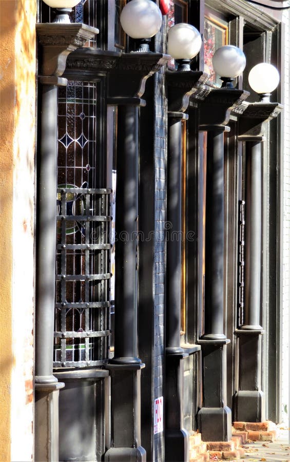 Row of City Storefronts with Black Columns and White Globe Lights Stock ...