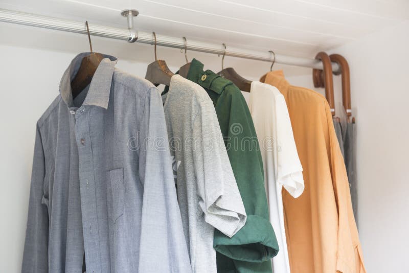 Row of Clothes Hanging in Wardrobe Stock Photo - Image of fabric, shirt ...