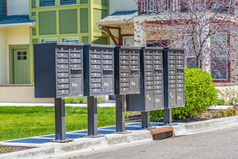 Row of Cluster Mailboxes with Numbered Compartments on a Sunlit ...