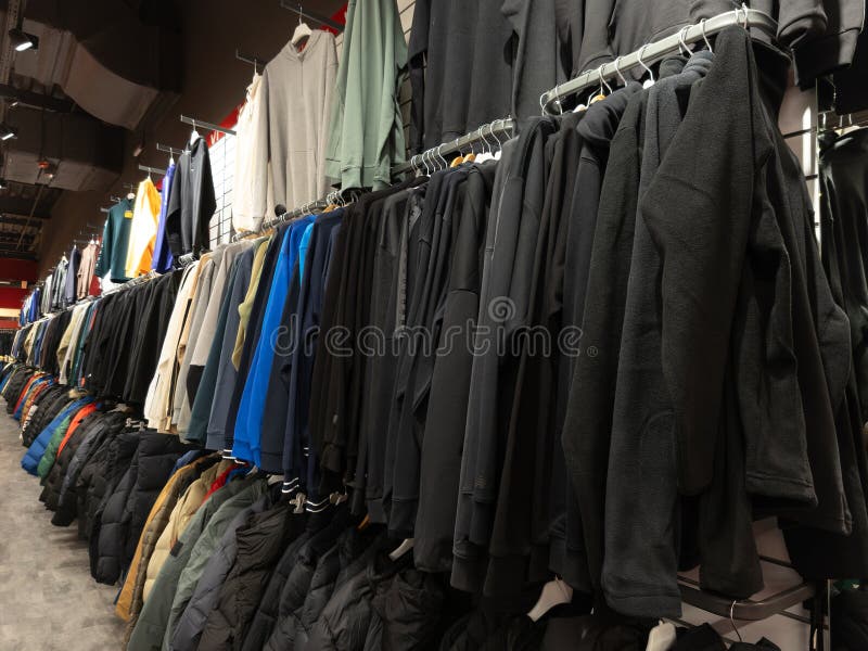 A Row of Coats Hanging on a Rack in a Clothing Store Stock Image ...